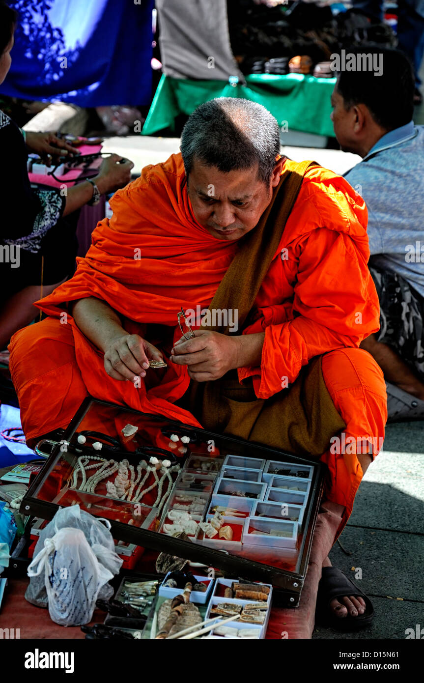 orange robed buddhist monk examine examining looking religious buddhist ...