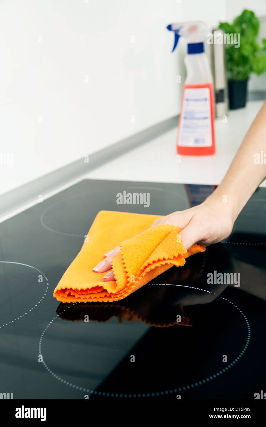 Hand cleaning induction stove Stock Photo - Alamy