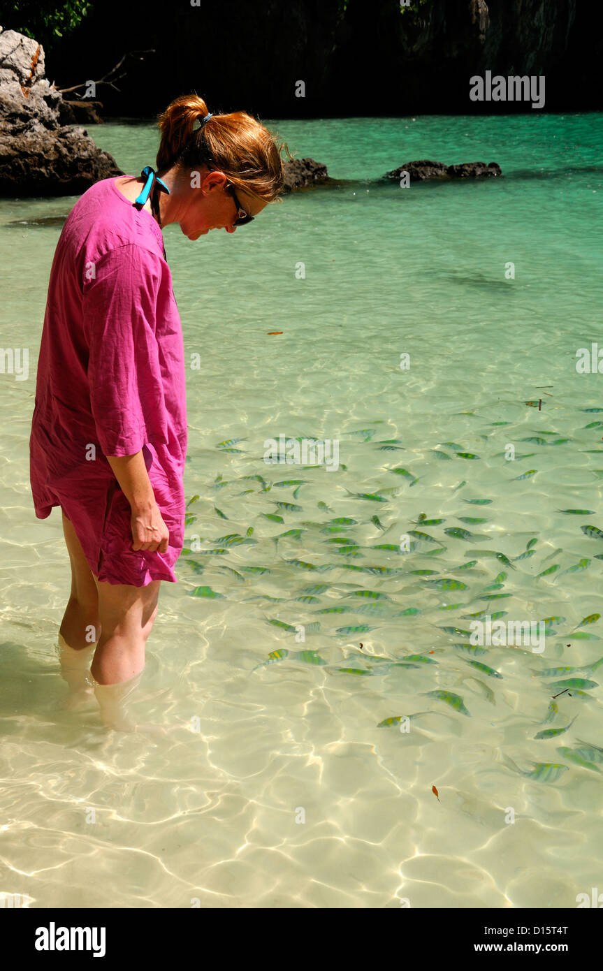 woman purple top staring looking fish tropical paradise lagoon Lading ...