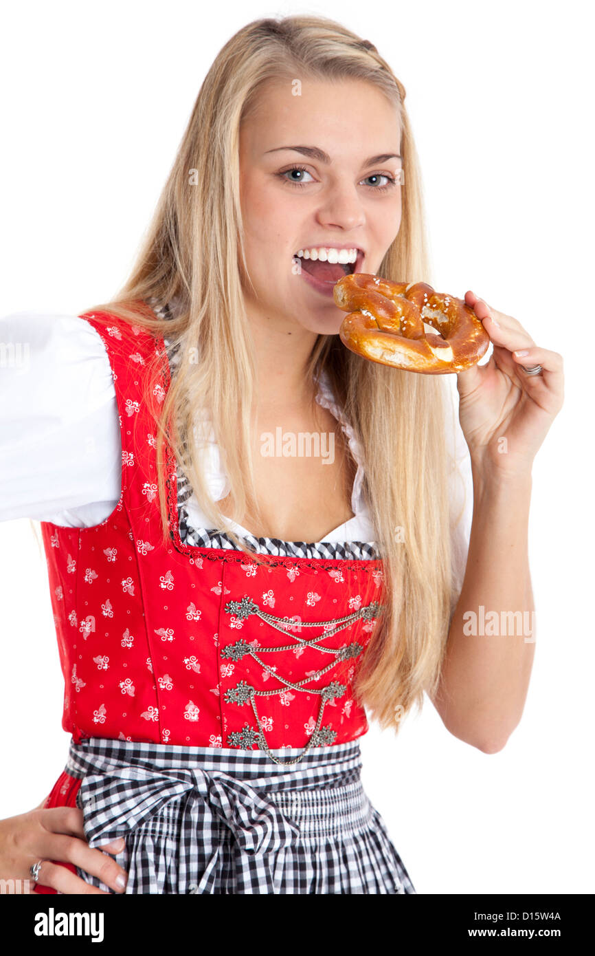 Woman in traditional costume biting into a pretzel Stock Photo - Alamy