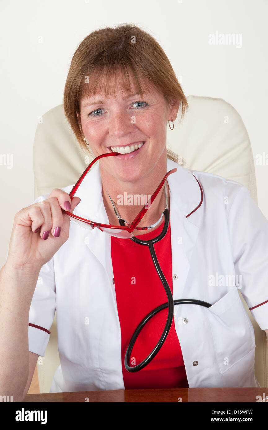 Female medical Doctor sitting at desk Stock Photo - Alamy