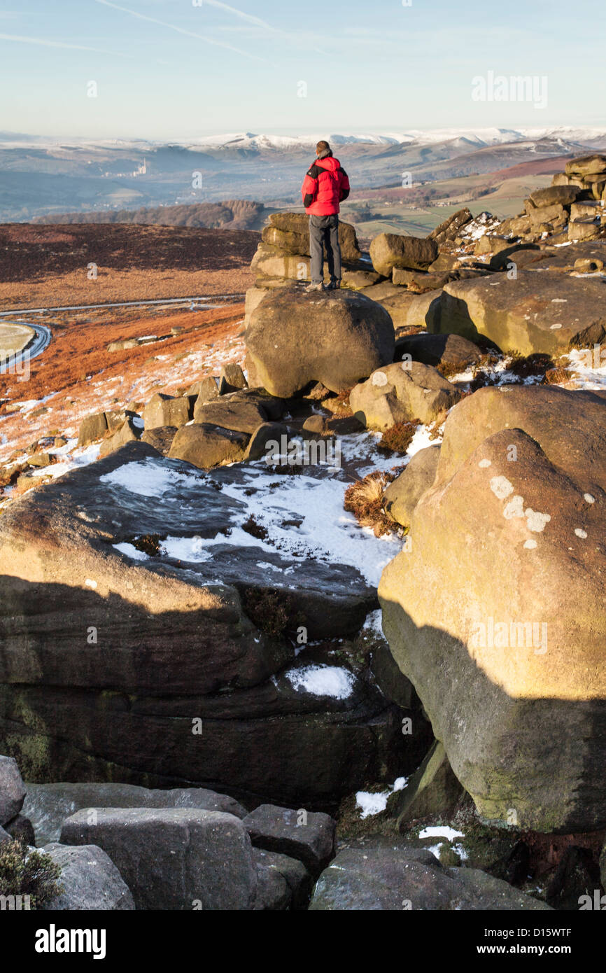 The Peak District National Park. Stanage Edge in winter with a male ...
