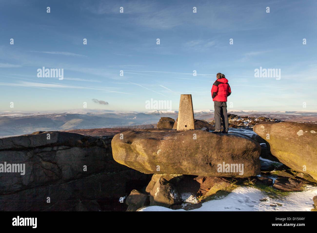 The Peak District National Park. Stanage Edge in winter with a male ...