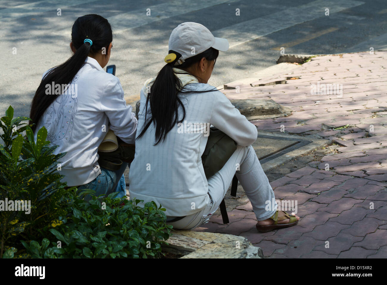 Girls sitting on the Street in Ho Chi Minh City, Vietnam Stock Photo ...