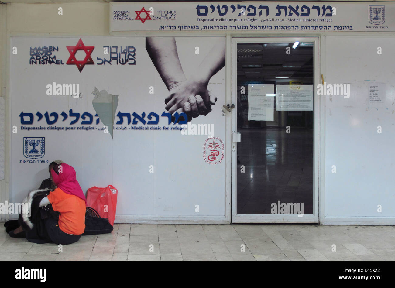 Migrant workers wait for treatment at a clinic for migrant workers and ...