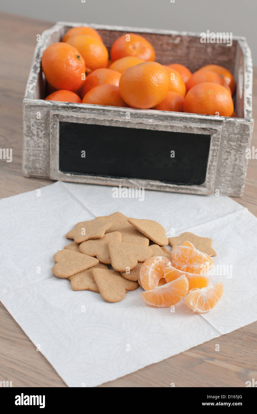 Slices of tangerine with gingerbread cookies with box of mandarins on ...