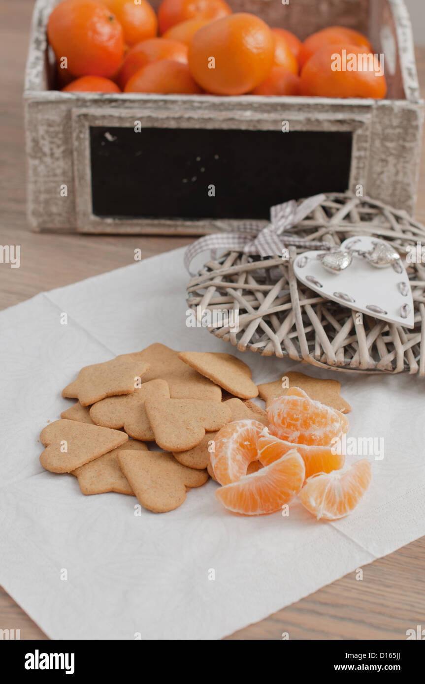 Slices of tangerine with gingerbread cookies with box of mandarins on ...
