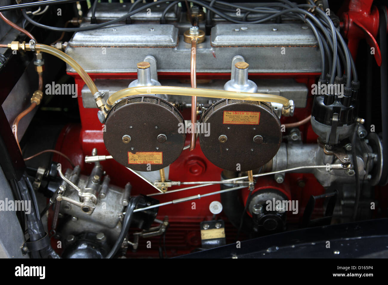 classic petrol driven engine showing carburators distributor, steering ...