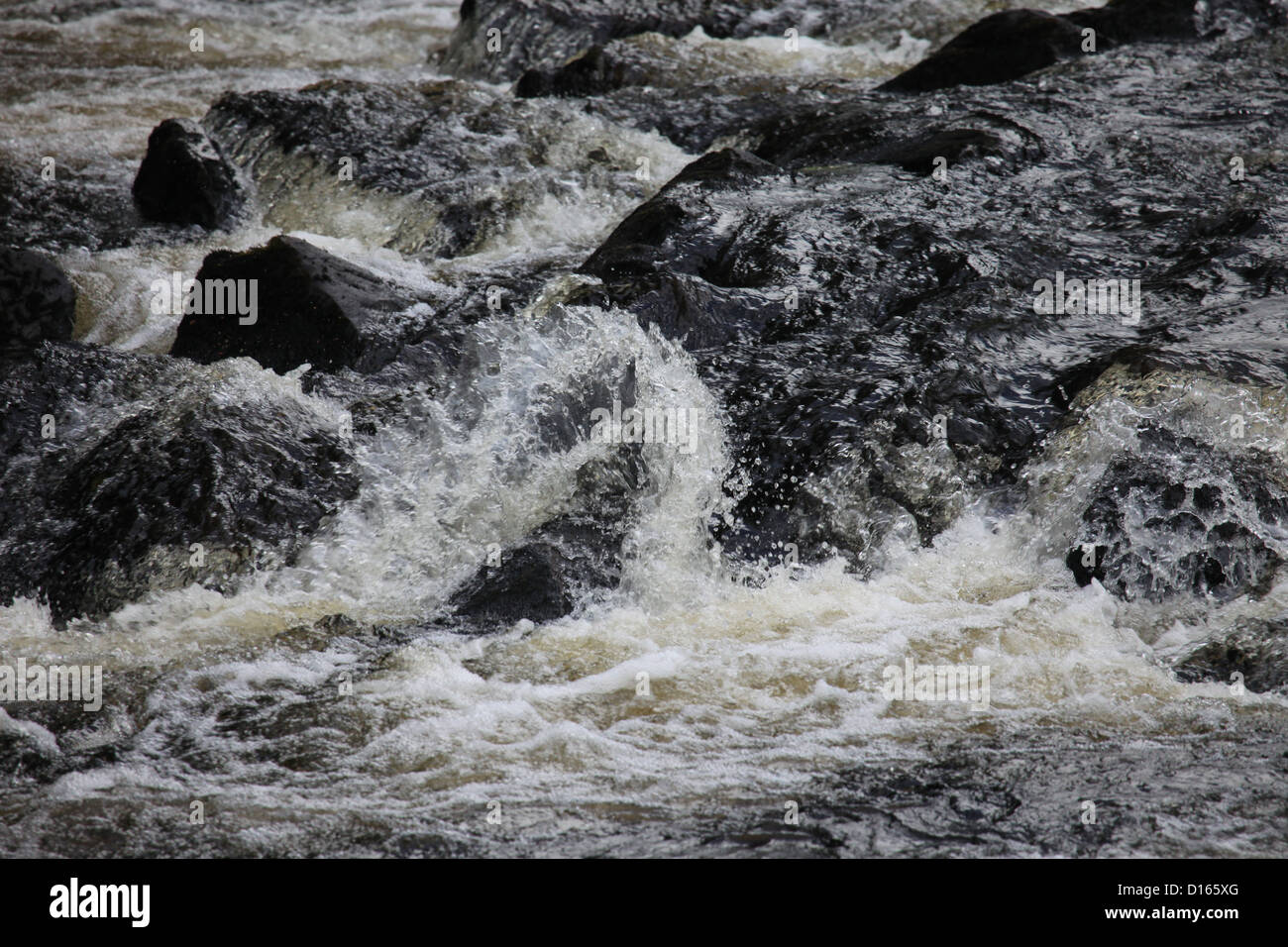 ireland, co county kerry, mountain stream quickly flowing over large ...