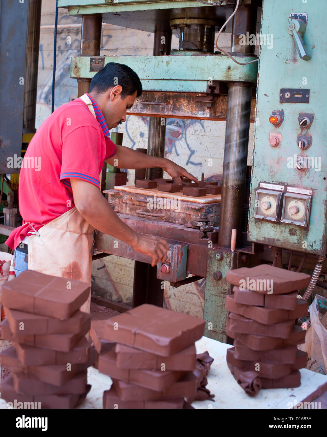 Worker in a clay tile factory,LA Stock Photo - Alamy
