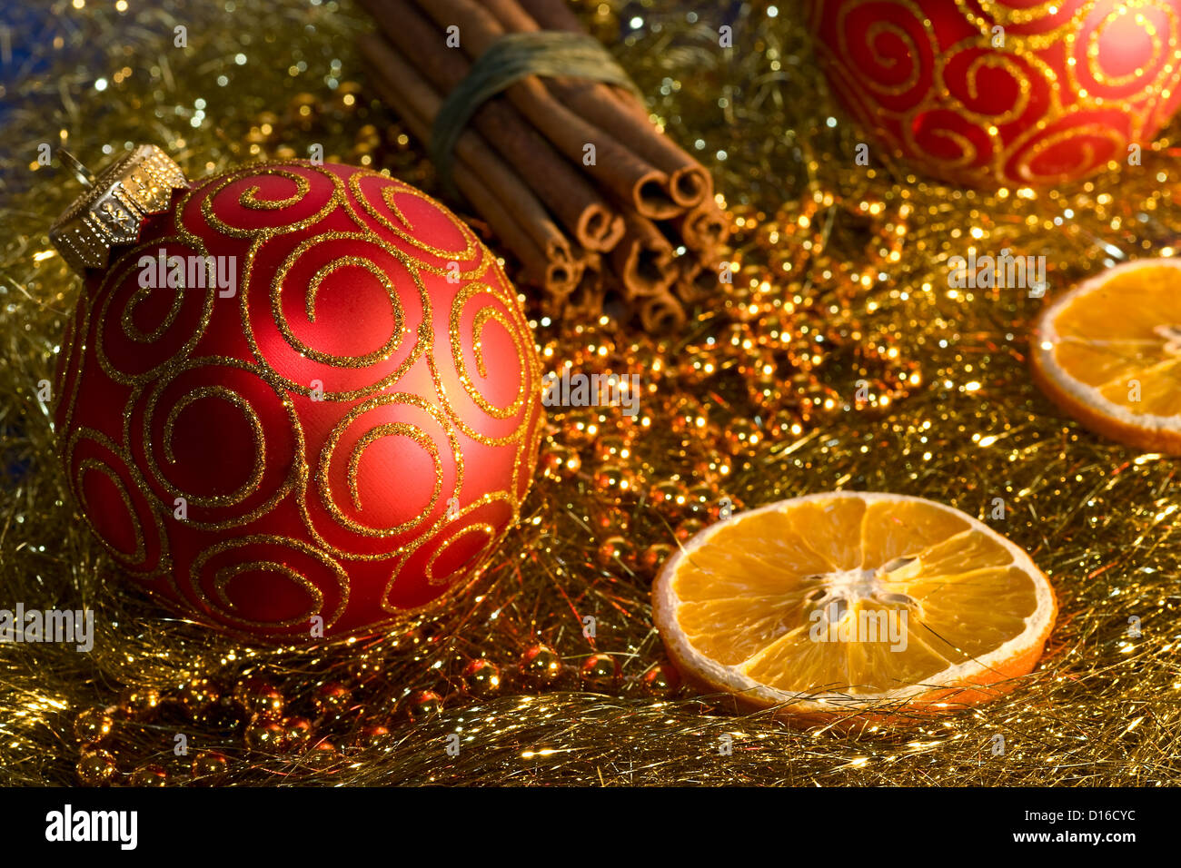 red christmas ball, cinnamon, orange and beads on gold background Stock ...
