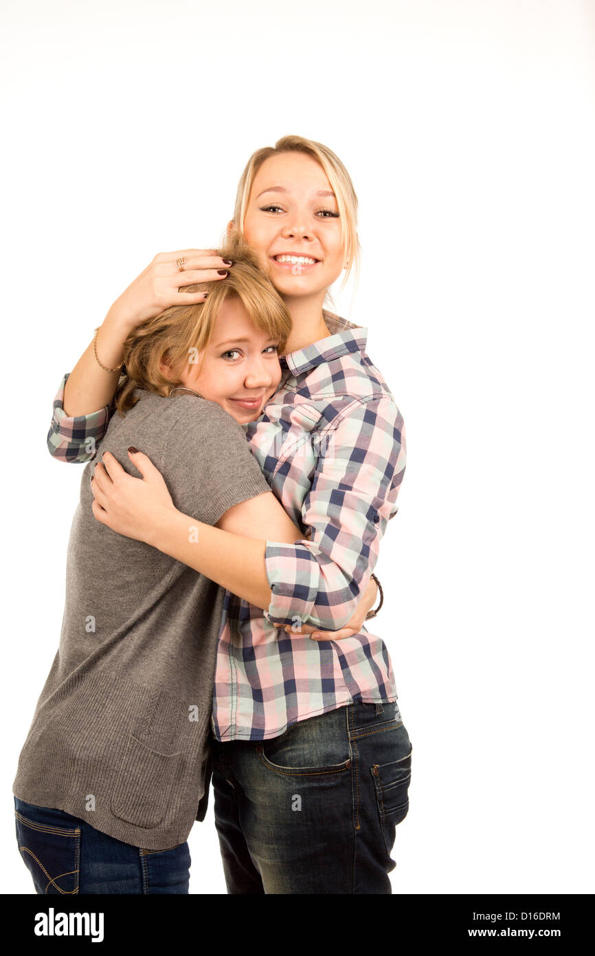 Two casual happy young female friends standing giving each other a ...