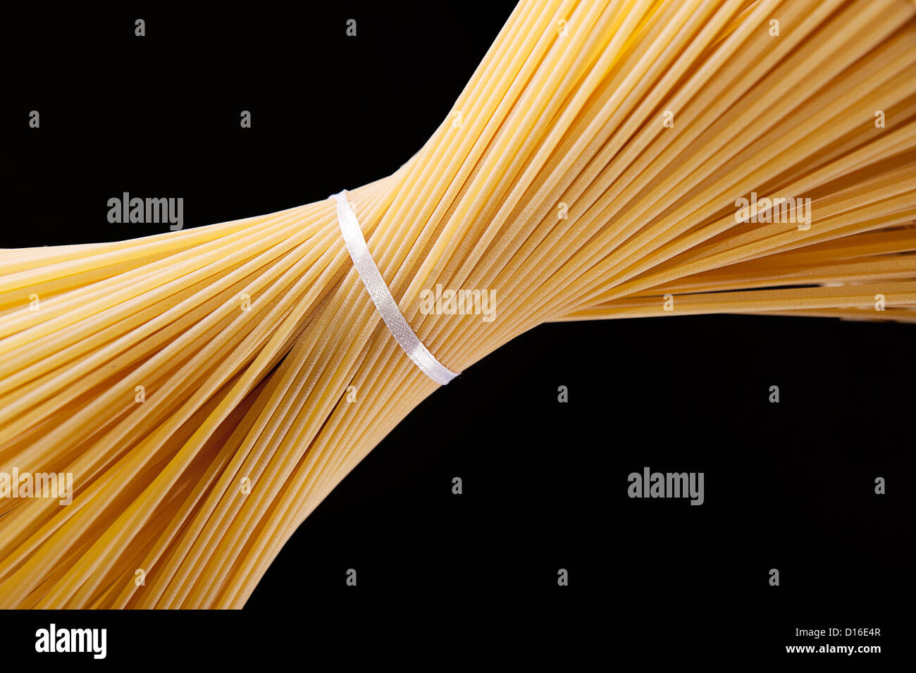 A bunch of long spaghetti pasta over dark background Stock Photo - Alamy
