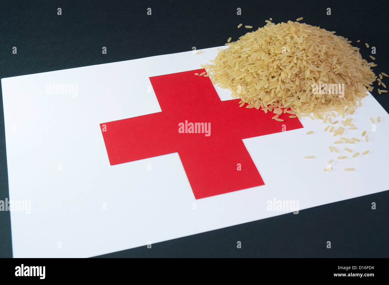 Red Cross flag and a pile of symbolic rice Stock Photo - Alamy