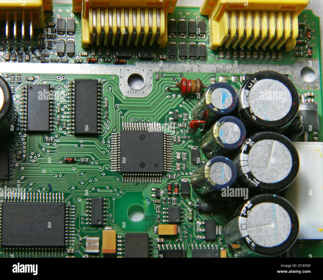 A printed circuit board with various electronic devices mounted on it ...