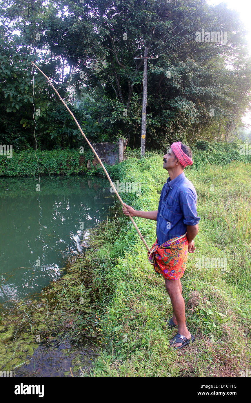 man standing with his fishing rod Stock Photo - Alamy