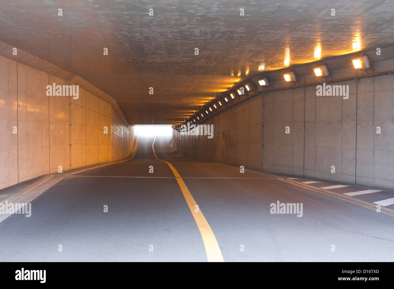 Lighted tunnel under the highway Stock Photo - Alamy