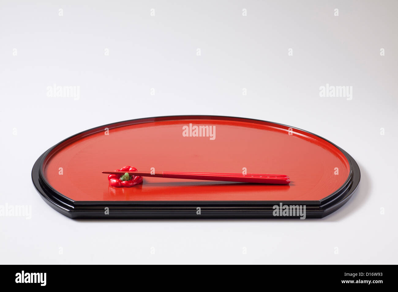 Red lacquered tray and chopsticks on white background Stock Photo - Alamy