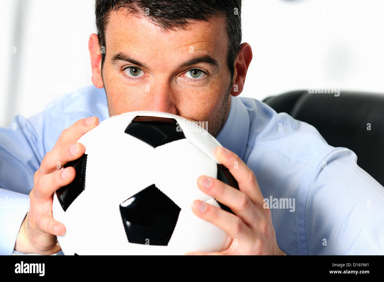 Business man with football Stock Photo - Alamy