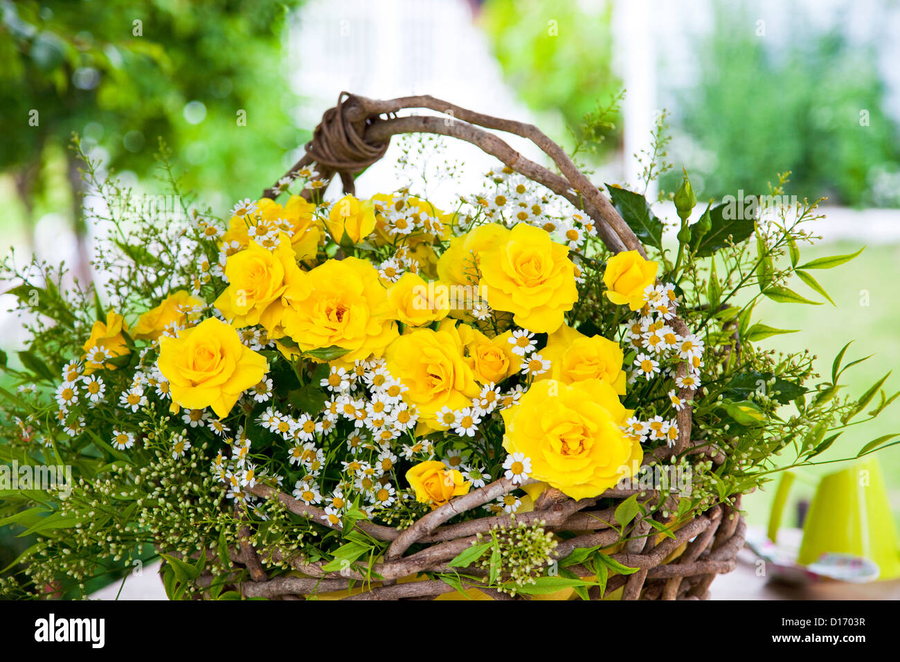 Basket of yellow roses and chamomile flowers Stock Photo - Alamy