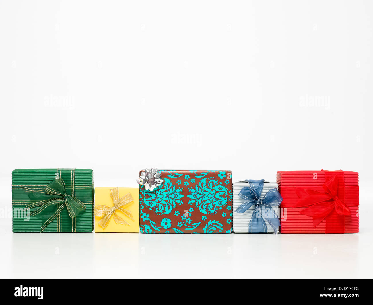closeup of different shaped colorful gift boxes in a row isolated on ...