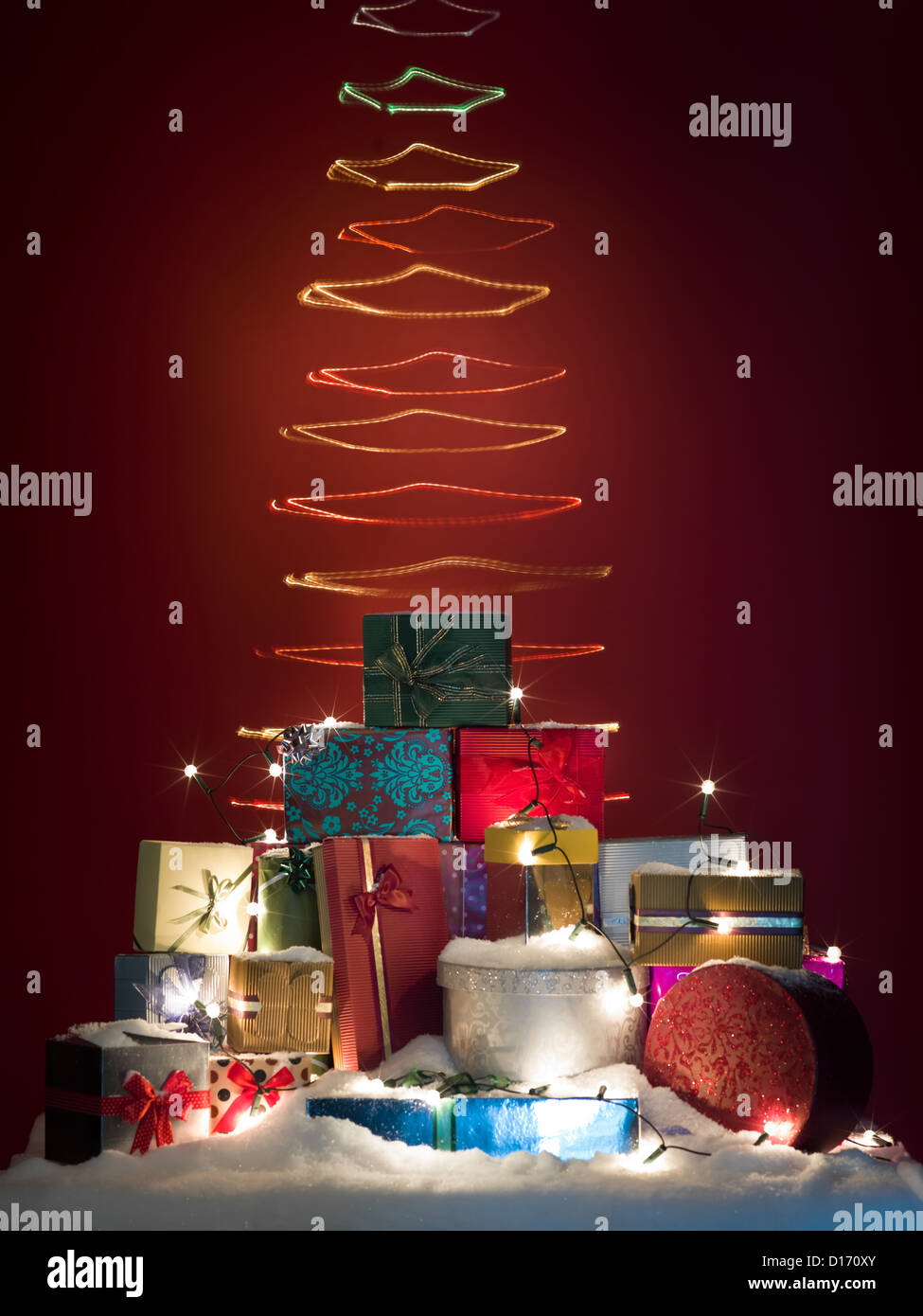 a pile of beautifully decorated gift boxes covered with snow and ...