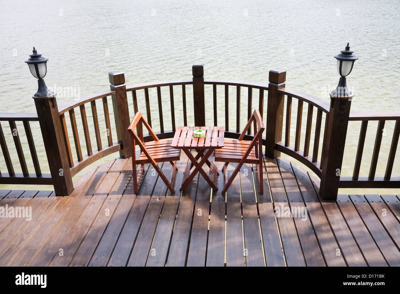 Patio with table and chairs by the riverside Stock Photo - Alamy