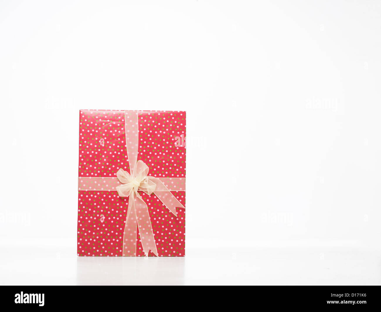 closeup of single colorful present wrapped with polka dots paper and ...