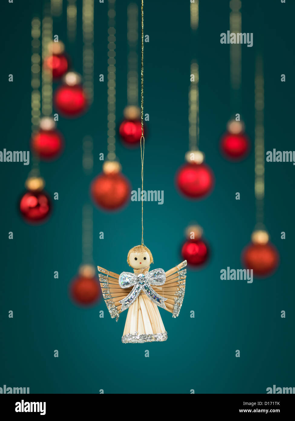 closeup of hanging christmas handmade tiny angel with golden threads on ...