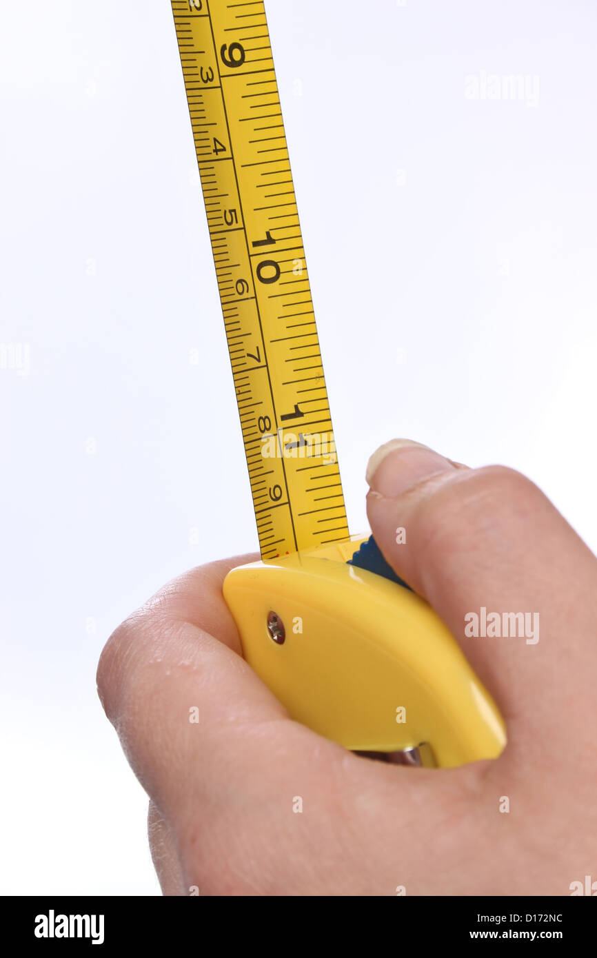 close up of a hand holding a tape measure Stock Photo - Alamy
