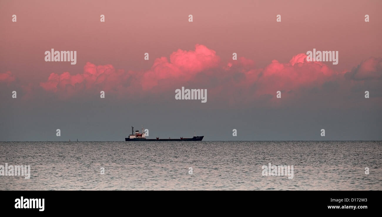 Red sunset over sea with ship on horizon Stock Photo - Alamy