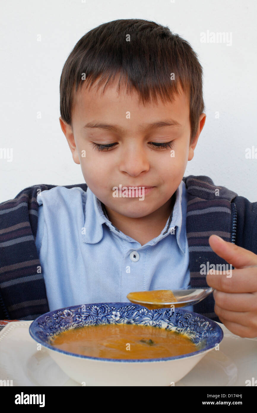 Child eating soup Stock Photo - Alamy