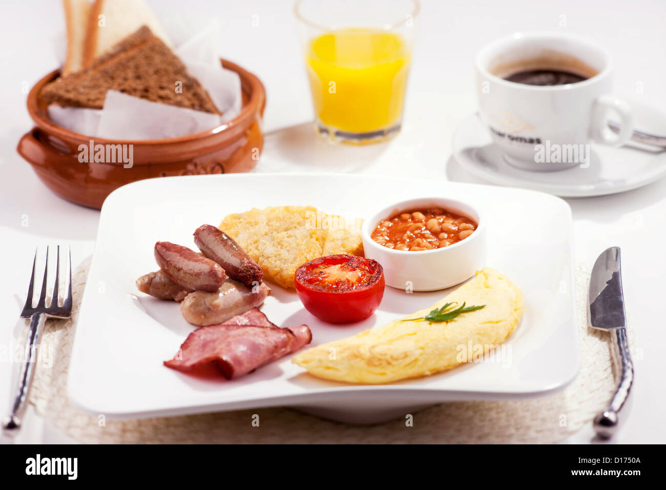 A traditional breakfast consists of bacon, sausage, tomato, hash browns ...