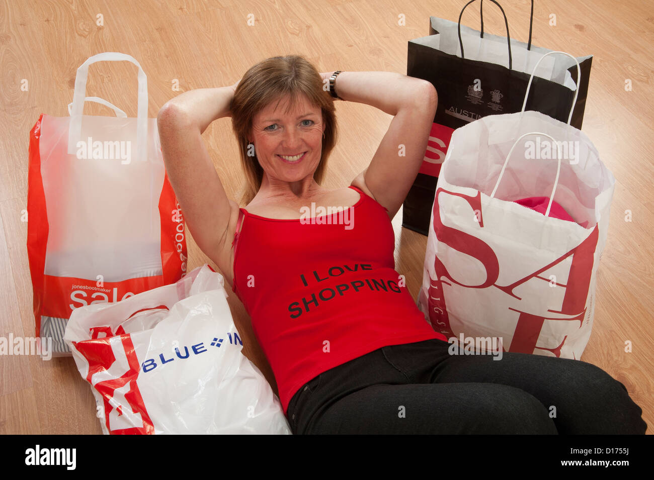 Woman who has been shopping with sales carrier bags Stock Photo - Alamy