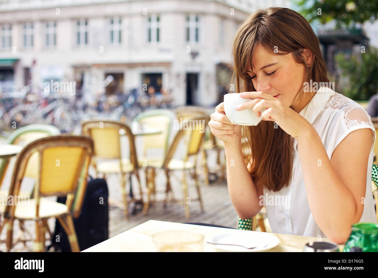 Woman enjoying the beautiful morning outdoors and smelling the coffee's ...