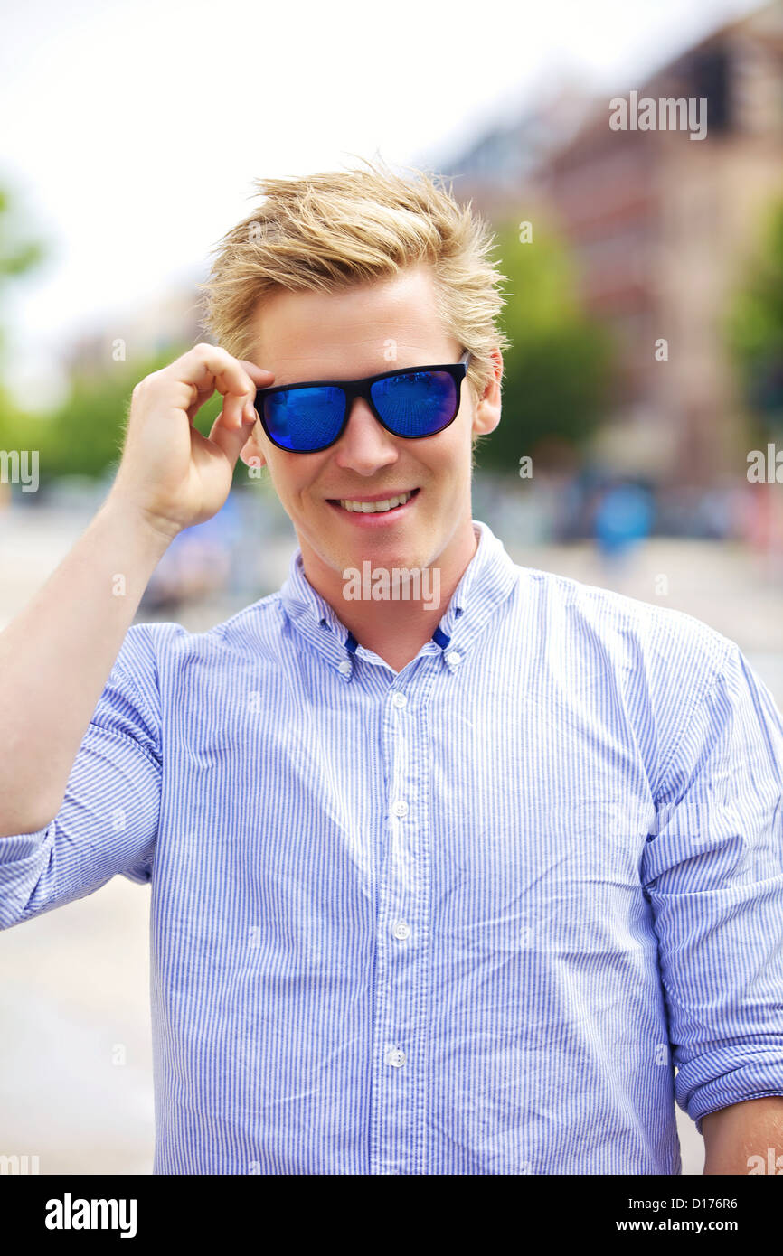 Portrait of a handsome and cool guy outdoors with his shades on Stock ...