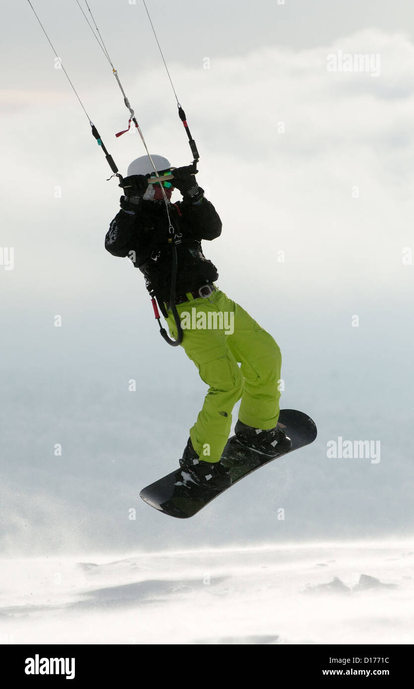 A snowkiter surfs through the snow on top of the Wasserkuppe, Germany ...