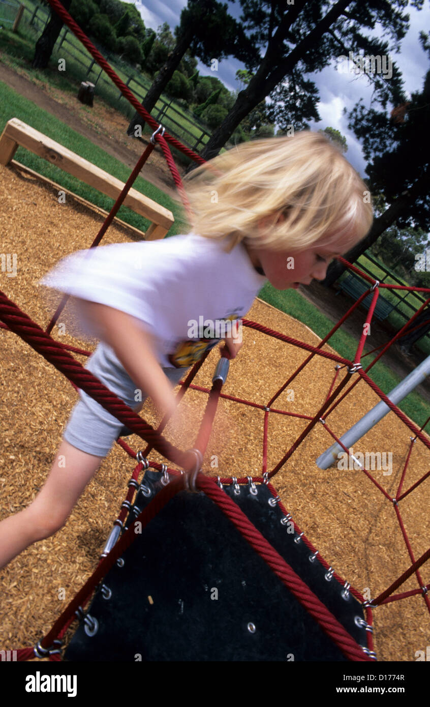 Child playing on playground equipment Stock Photo - Alamy