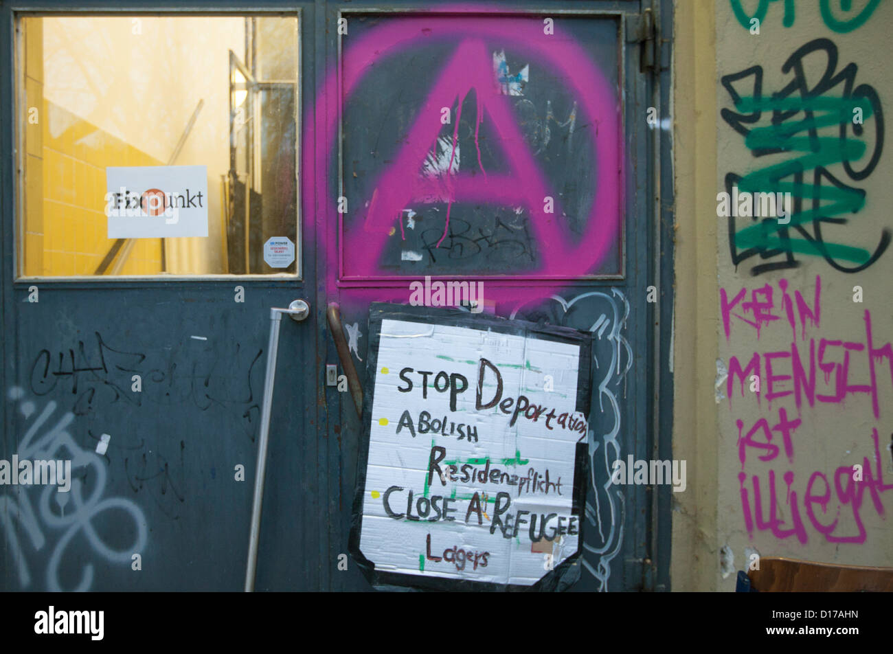 The door of a newly occupied building is decorated with a sign and ...