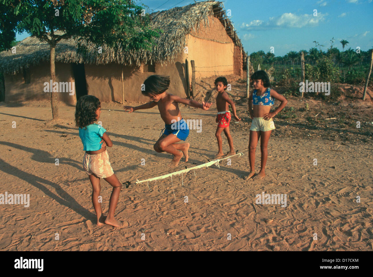 Children play skip the rope game in a landless people settlement in ...