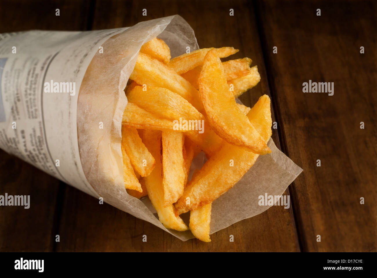 French fries in rolled newspaper packet or packaging Stock Photo - Alamy