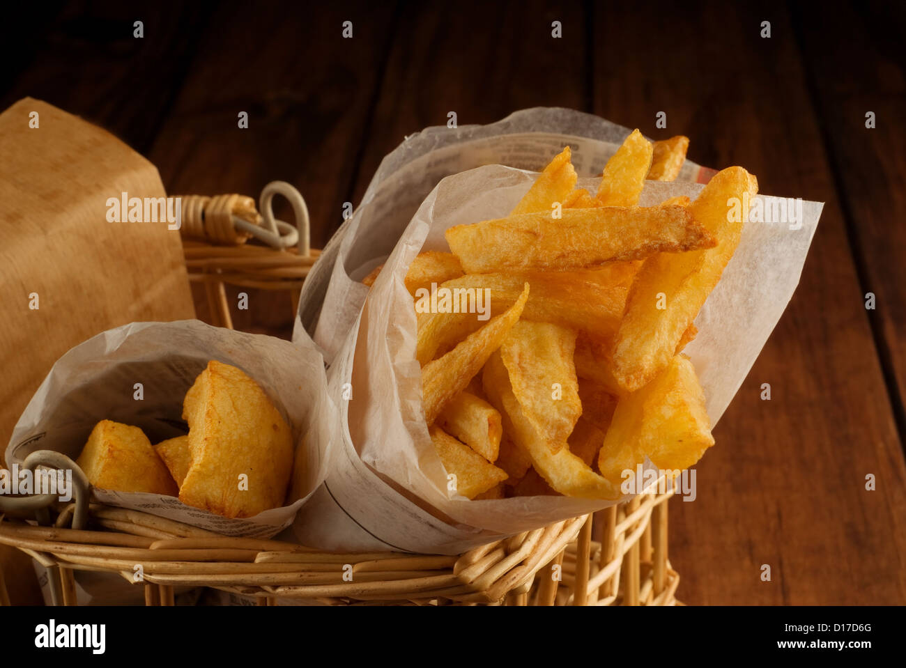French fries in rolled newspaper packet or packaging Stock Photo - Alamy