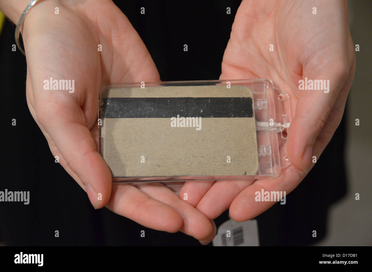 A woman holds the world's first credit card in her hands at the Sotheby ...