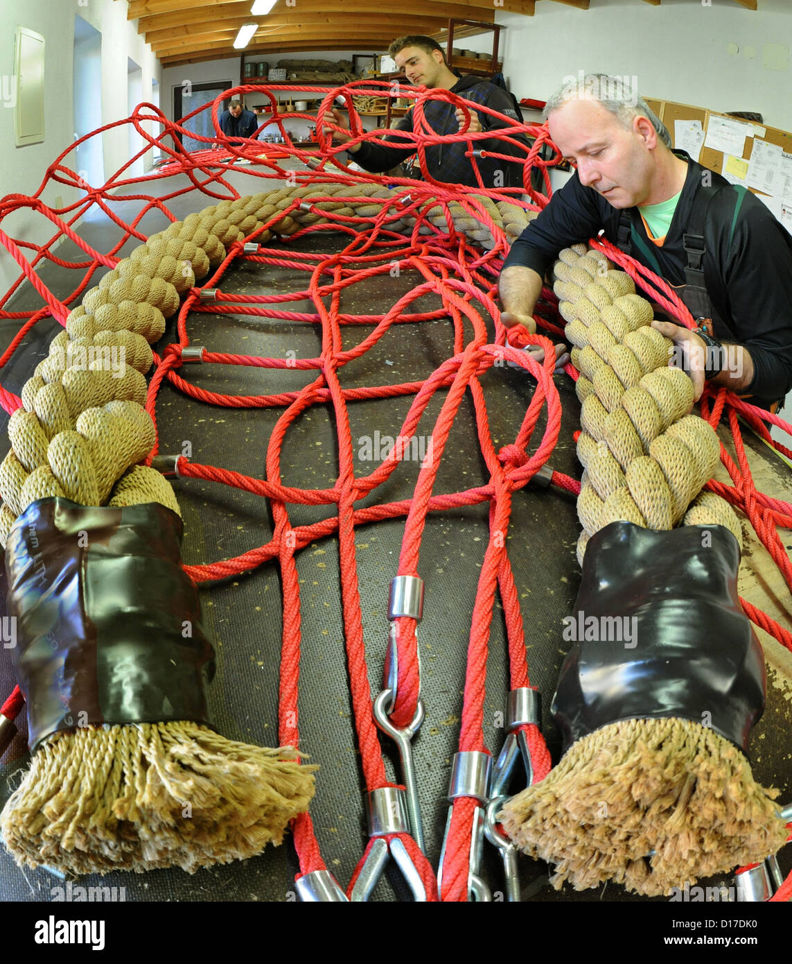 Employees of rope factory Prutz work on a hanging bridge for a children ...