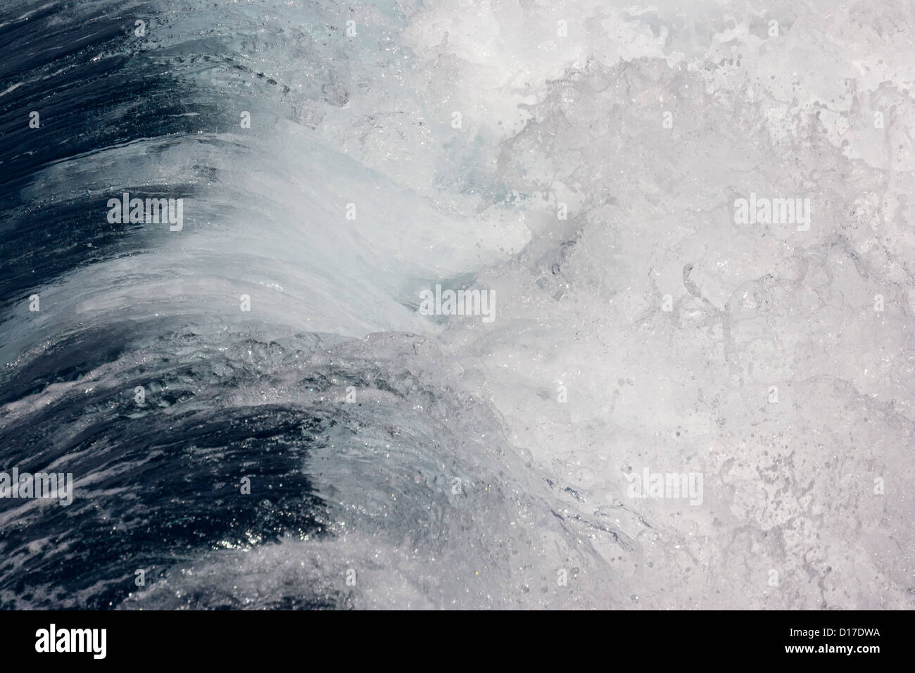 Waves breaking, wake off the side of a cargo ship in deep ocean Stock ...