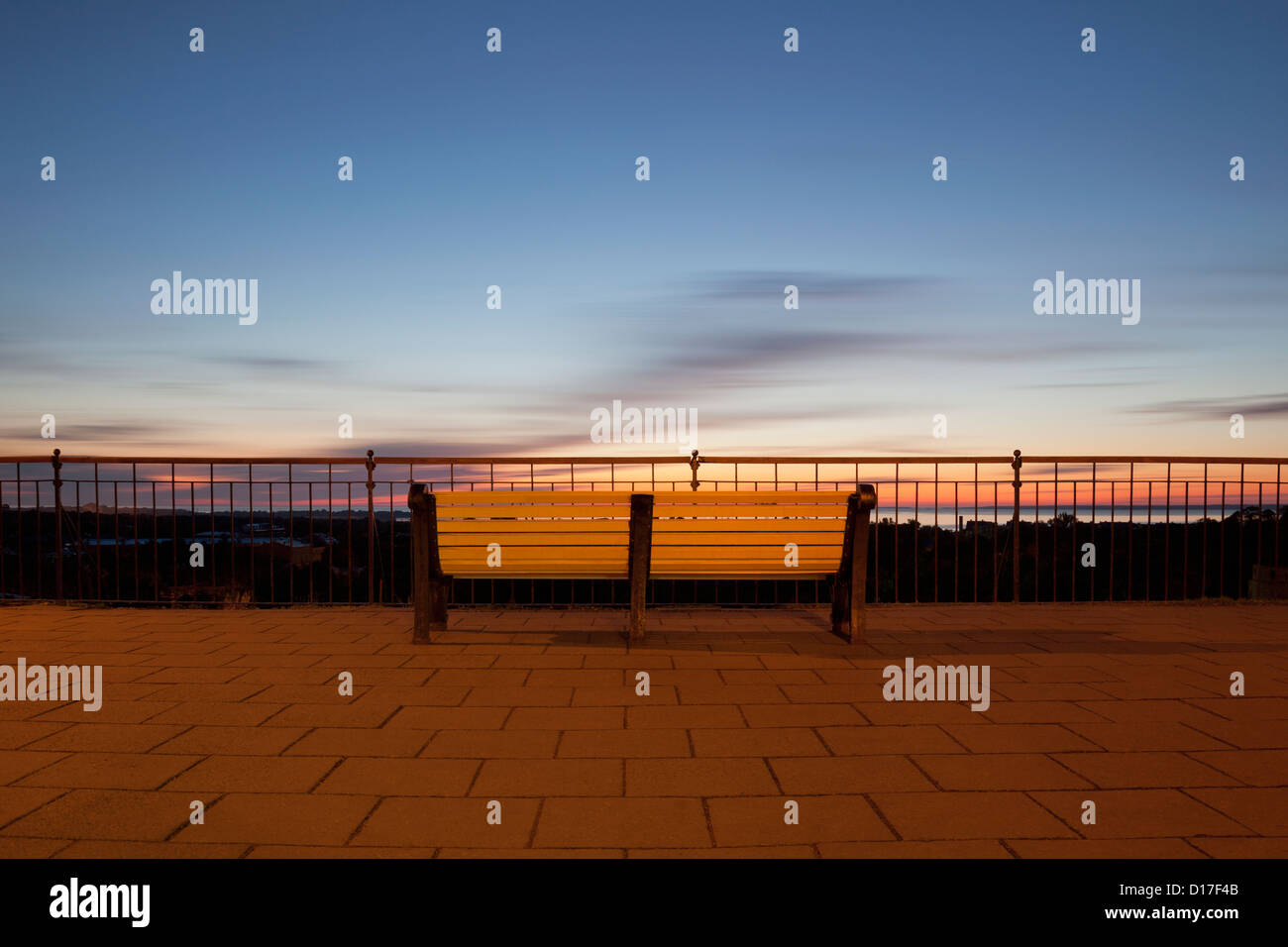 Bench by railing overlooking ocean Stock Photo - Alamy