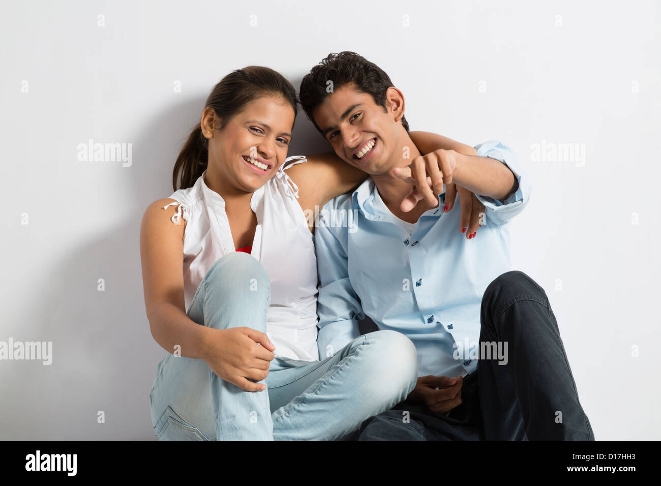 Portrait of a couple sitting together and smiling Stock Photo - Alamy