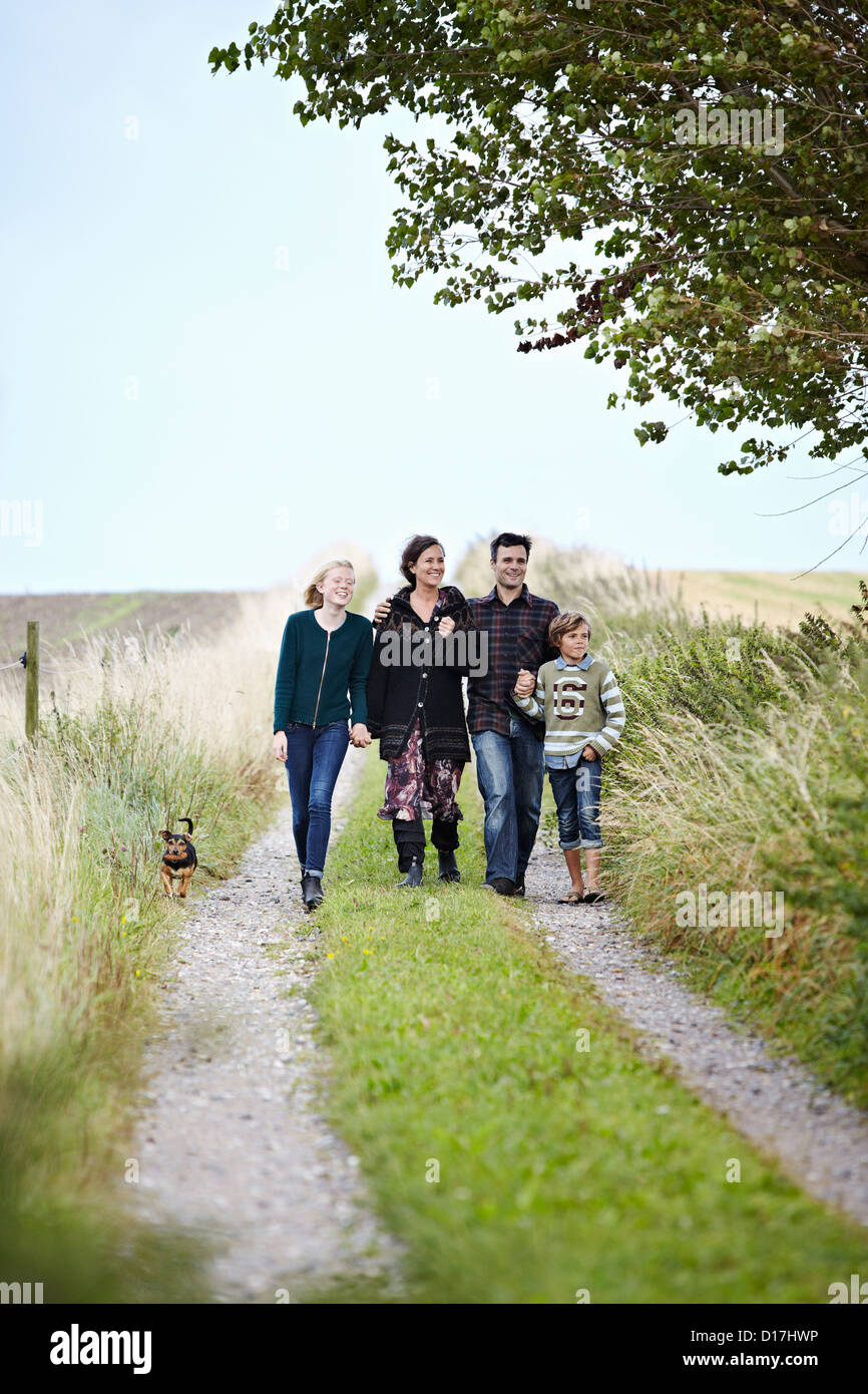 Family walking together on rural road Stock Photo - Alamy