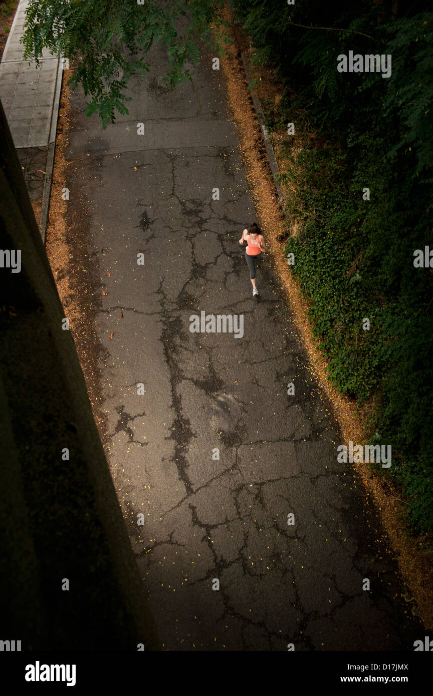 Aerial view of woman running on road Stock Photo - Alamy