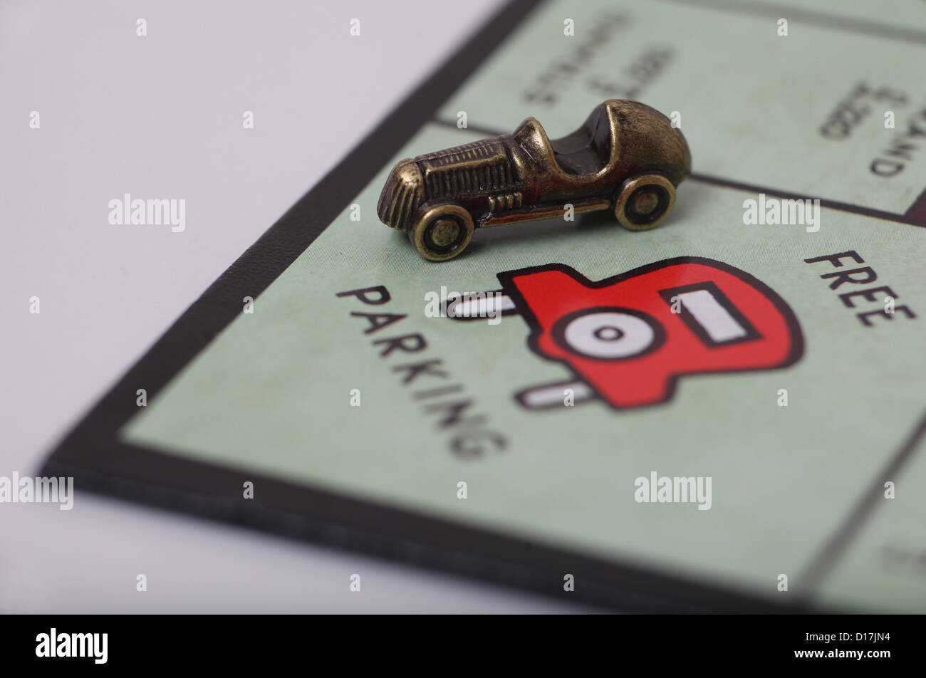 Monopoly free parking square and car players piece Stock Photo - Alamy